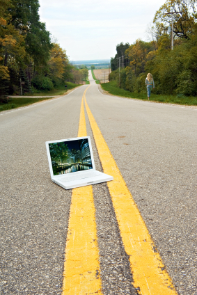 Laptop in Road with Woman Walking Away